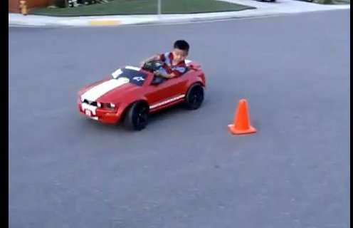 A little kid drifting in a Power Wheels Ford Mustang | Torque News